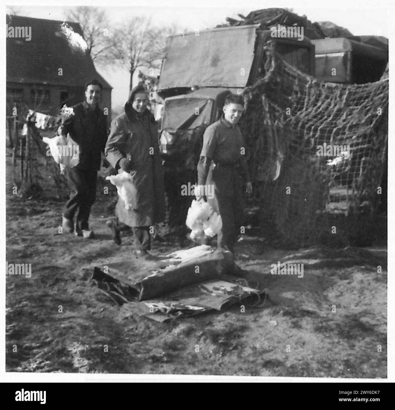 Three soldiers—L/Bdr. Allan, Gnr. Neil, and Gnr. Pathy—carry the ...