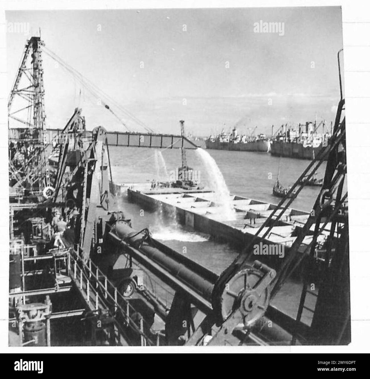 PHOTOGRAPHS OF PREFABRICATED PORT, ETC. - Breakwater units being filled ...