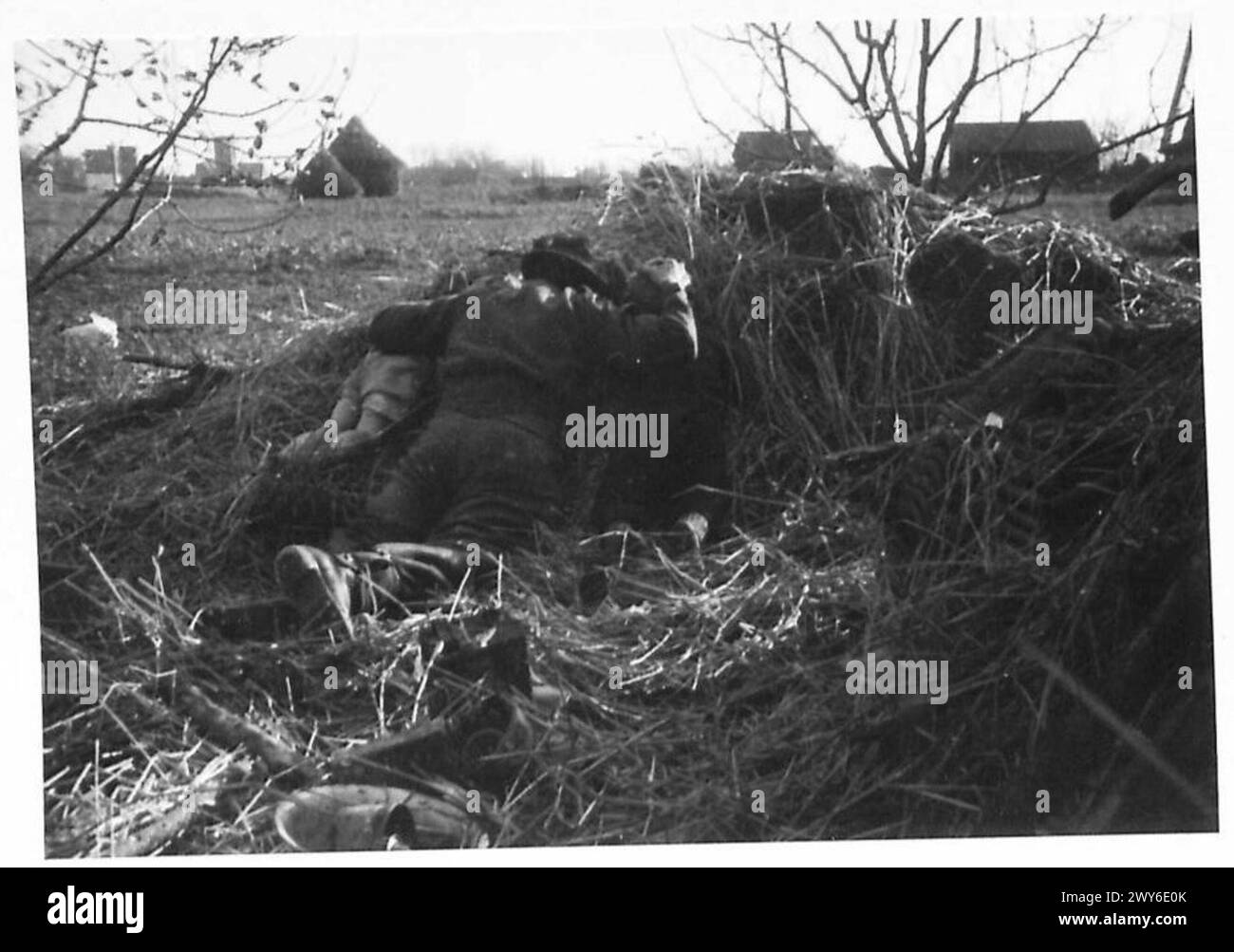 Near the front line in Holland, a British soldier directs two Dutch children to take cover while ...
