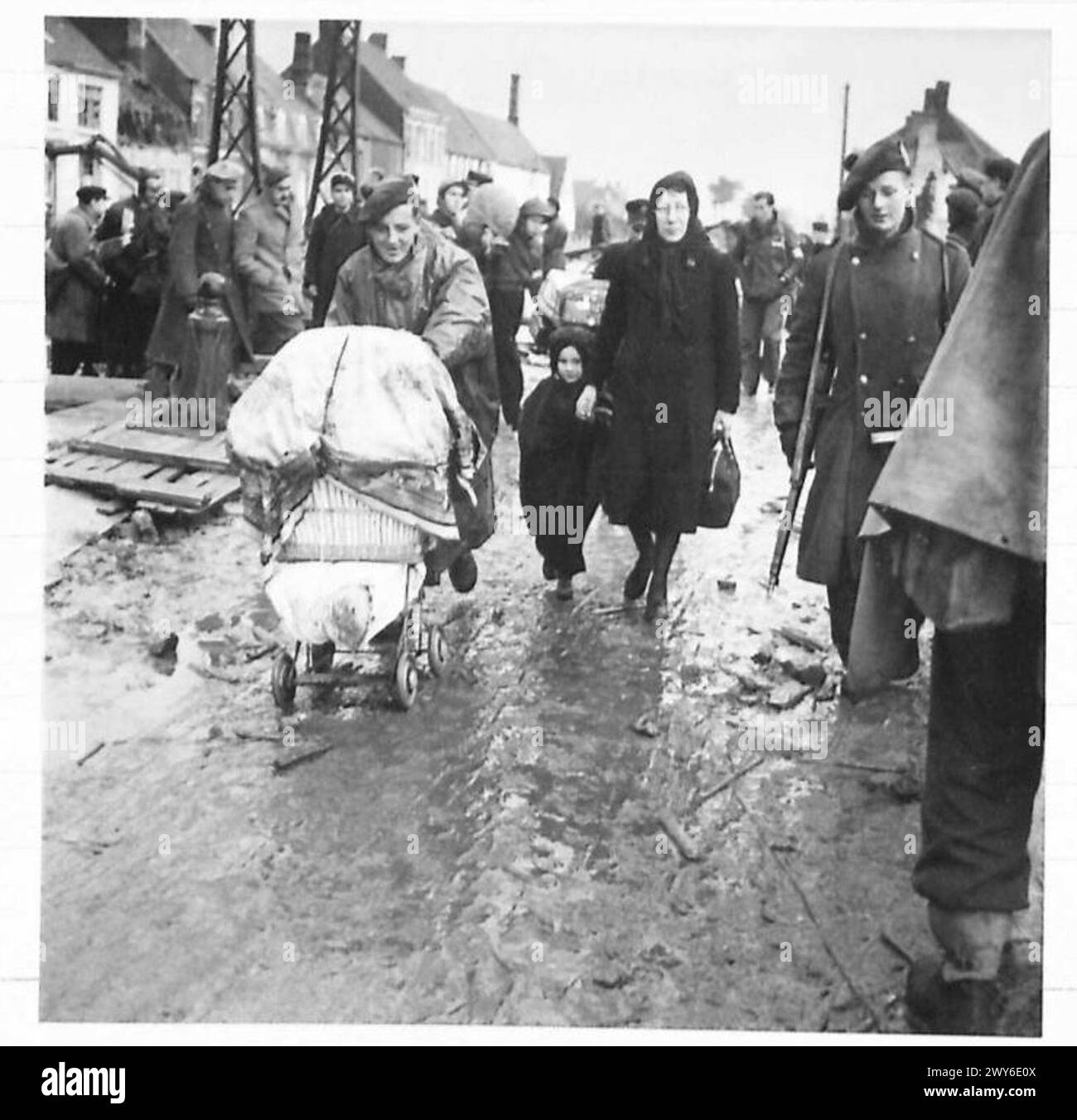 Refugees are shown crossing the canal at Grande Mille Bruggke during a ...