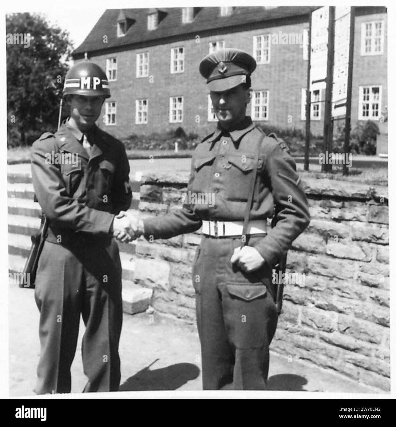 Private D.M. Newgard of the U.S. Military Police shakes hands with L ...