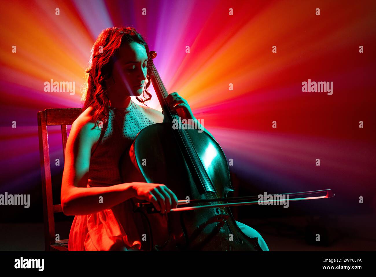 Portrait of female cellist performing classical melodies with radiant ...