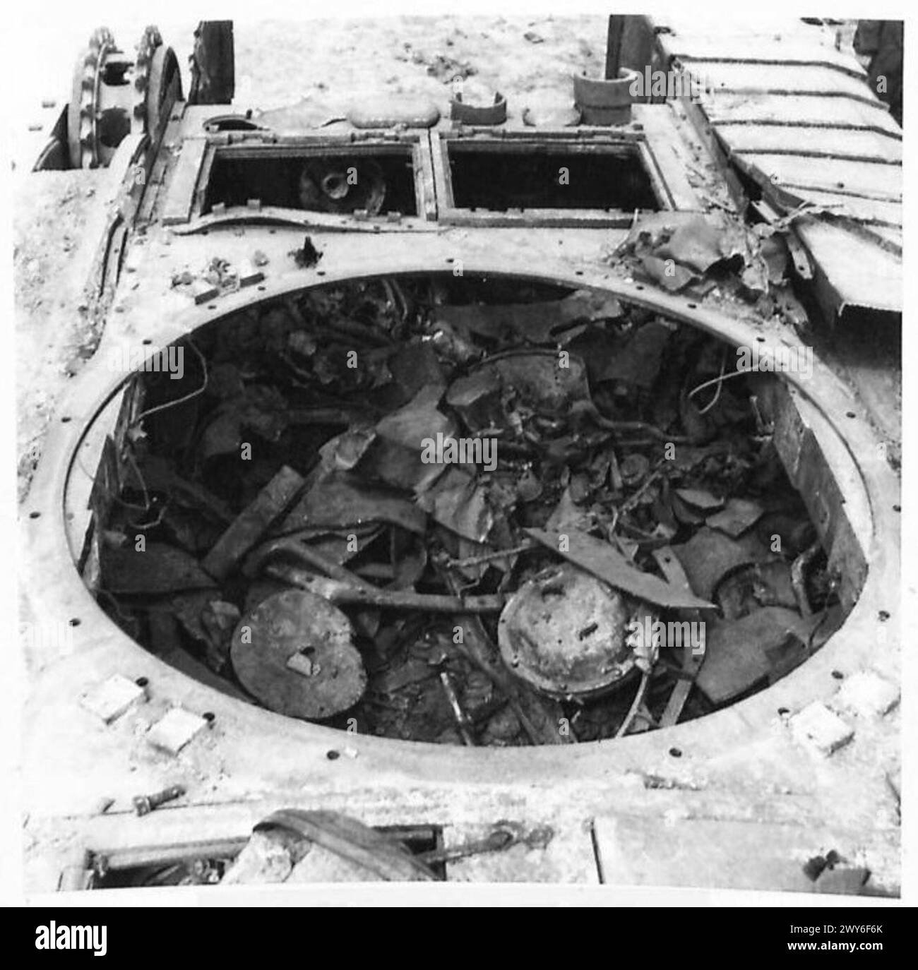 A damaged Churchill tank turret is shown at a Normandy vehicle dump ...