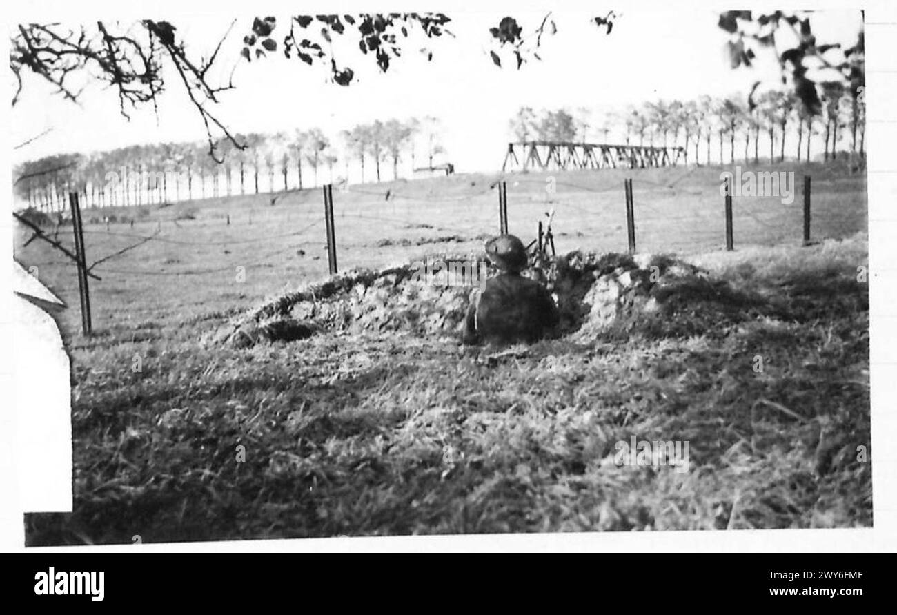 ADVANCE TOWARDS RIVER MAAS - Bren gun position with blown bridge in ...