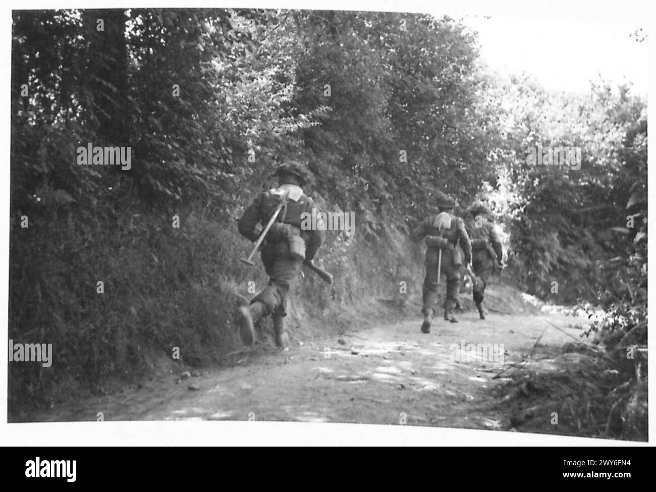 THE ATTACK IN THE CENTRAL SECTOR - Infantrymen rushing forward along a ...