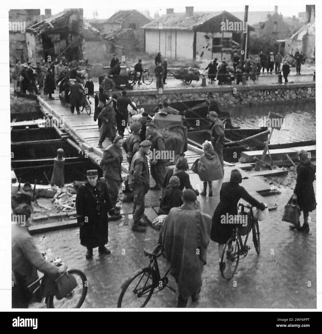 60-H0UR TRUCE AT DUNKIRK. - Refugees crossing the bridge over canal at ...
