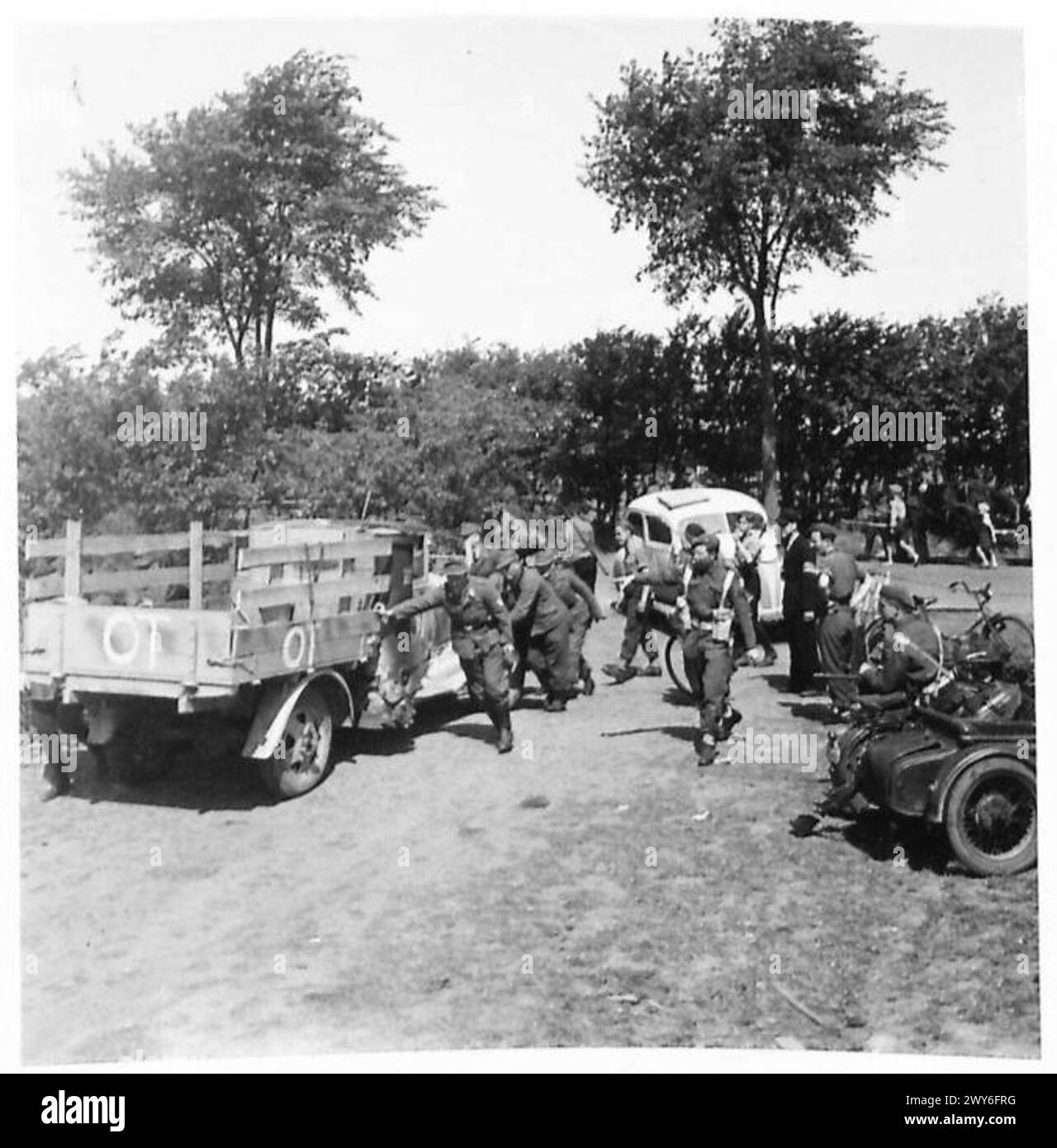 German soldiers bring vehicles for inspection and disarmament while ...