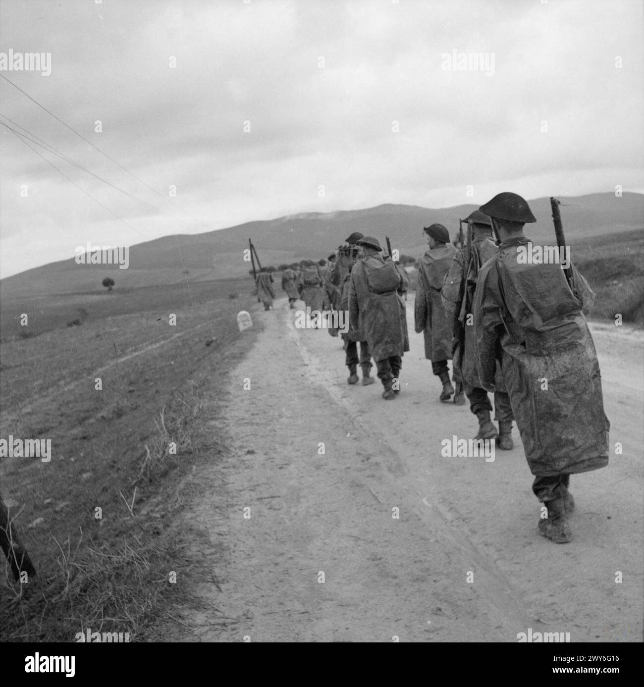 Men of the 2nd Battalion, Coldstream Guards advance on the road to ...