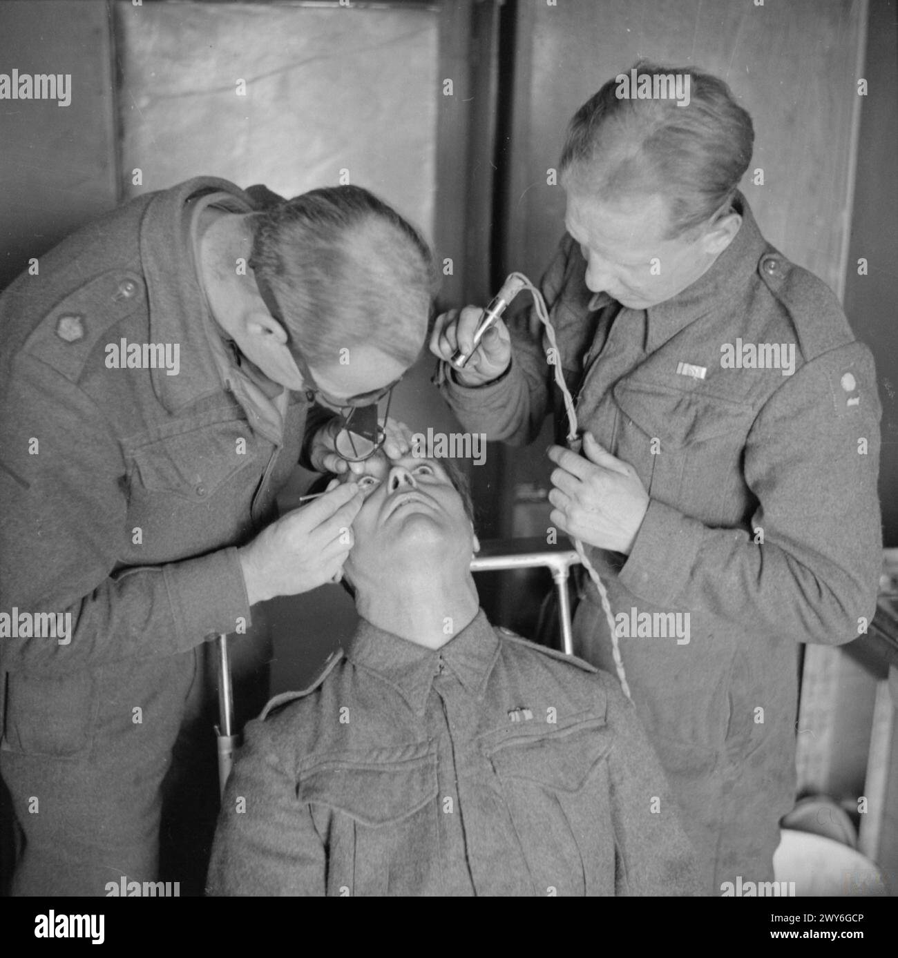 Major Patton RAMC, assisted by Private A. Haggard, removes a foreign ...