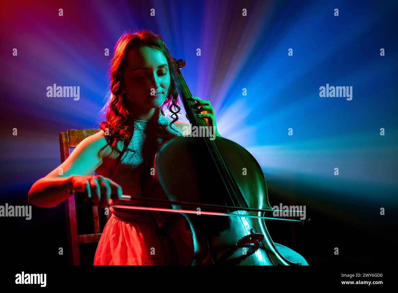 Portrait of female cellist performing classical melodies with radiant ...