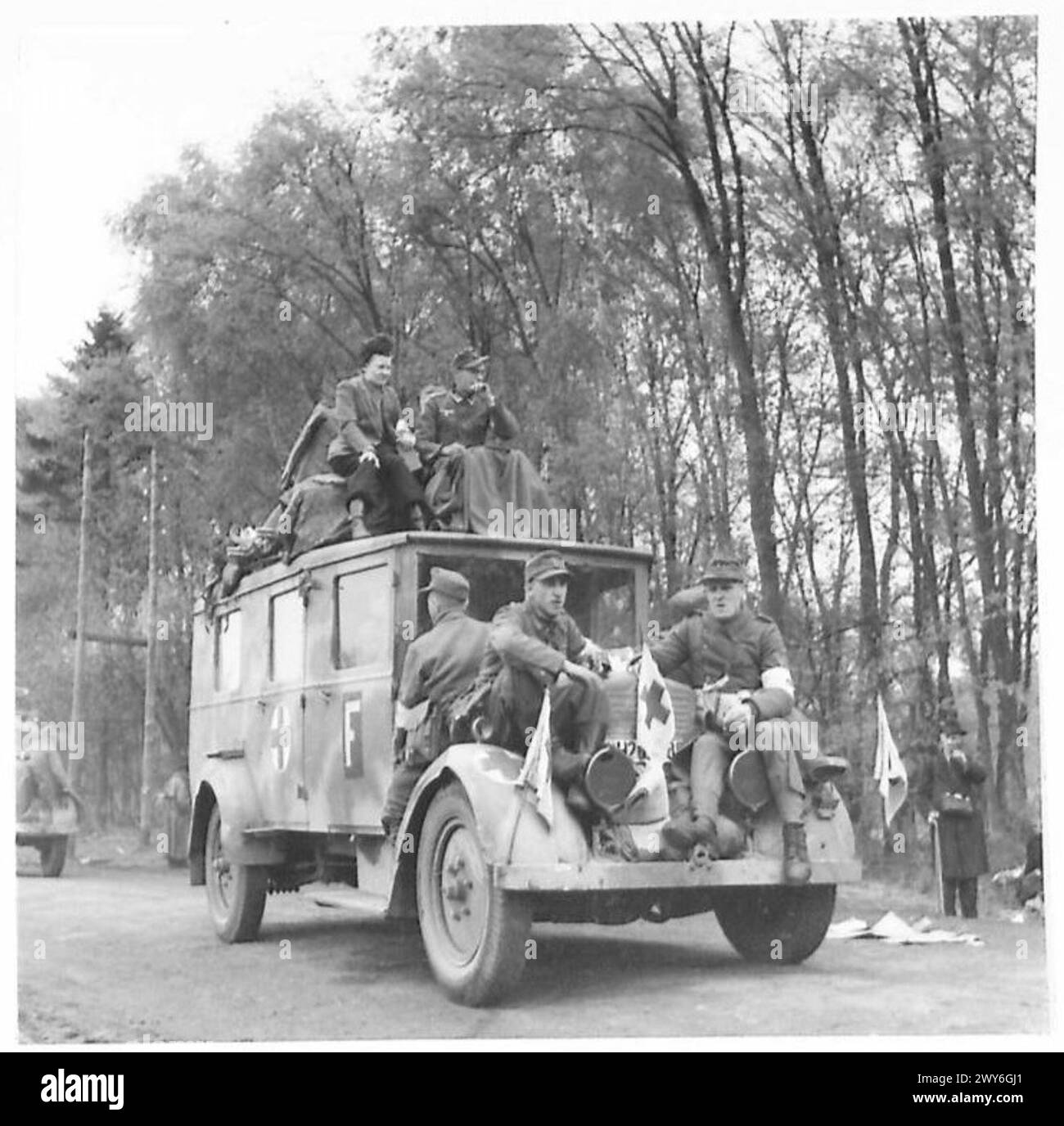 German troops use an ambulance for transport while surrendering to the ...