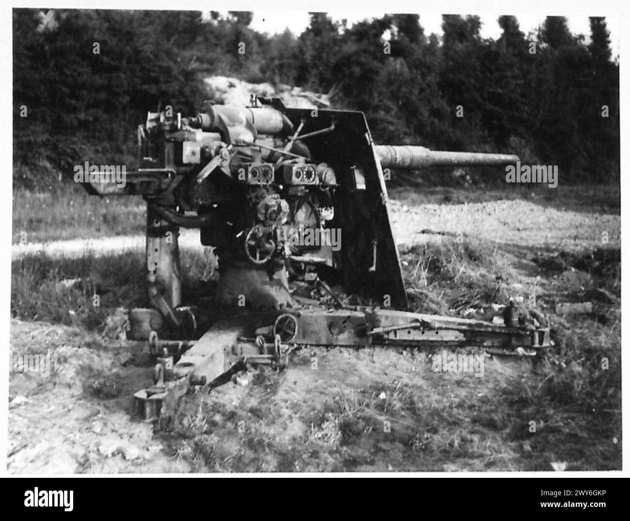 AFTER THE BOMBING AND THE SHELLING - A German 88mm gun by the railway ...