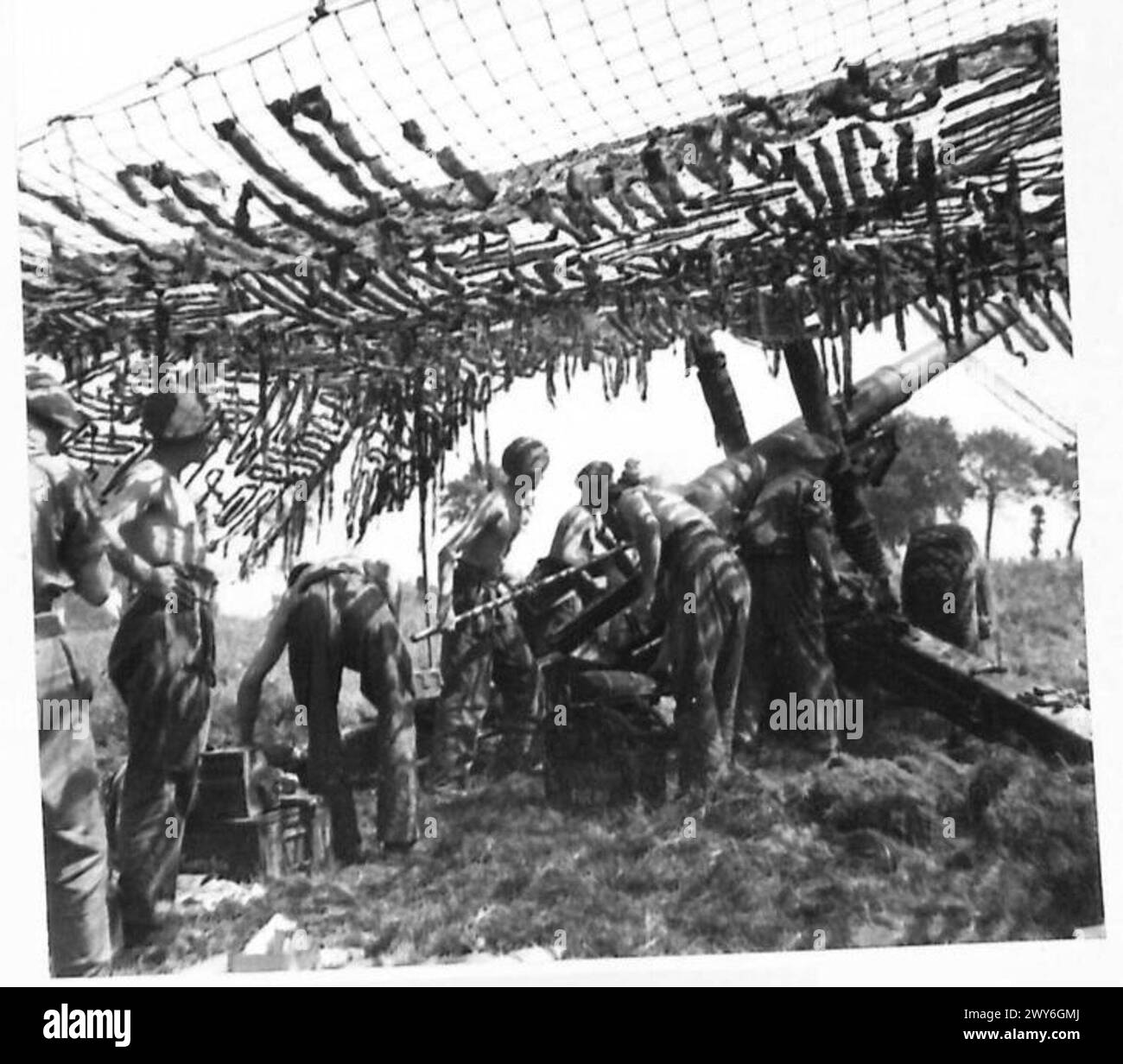 THE ATTACK ON MONT PINCON - Gunners stripped to the waist because of the hot weather, in action ...