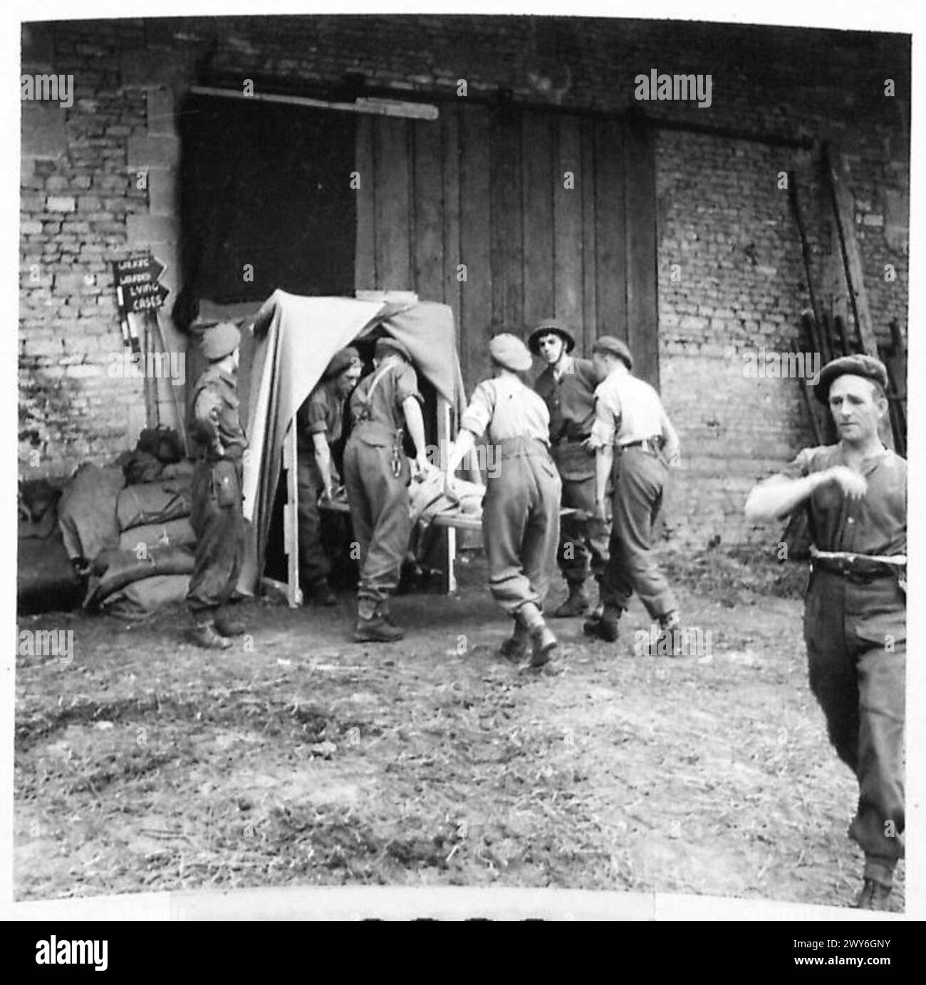 TREATMENT AND EVACUATION OF WOUNDED - The casualty being carried from ...