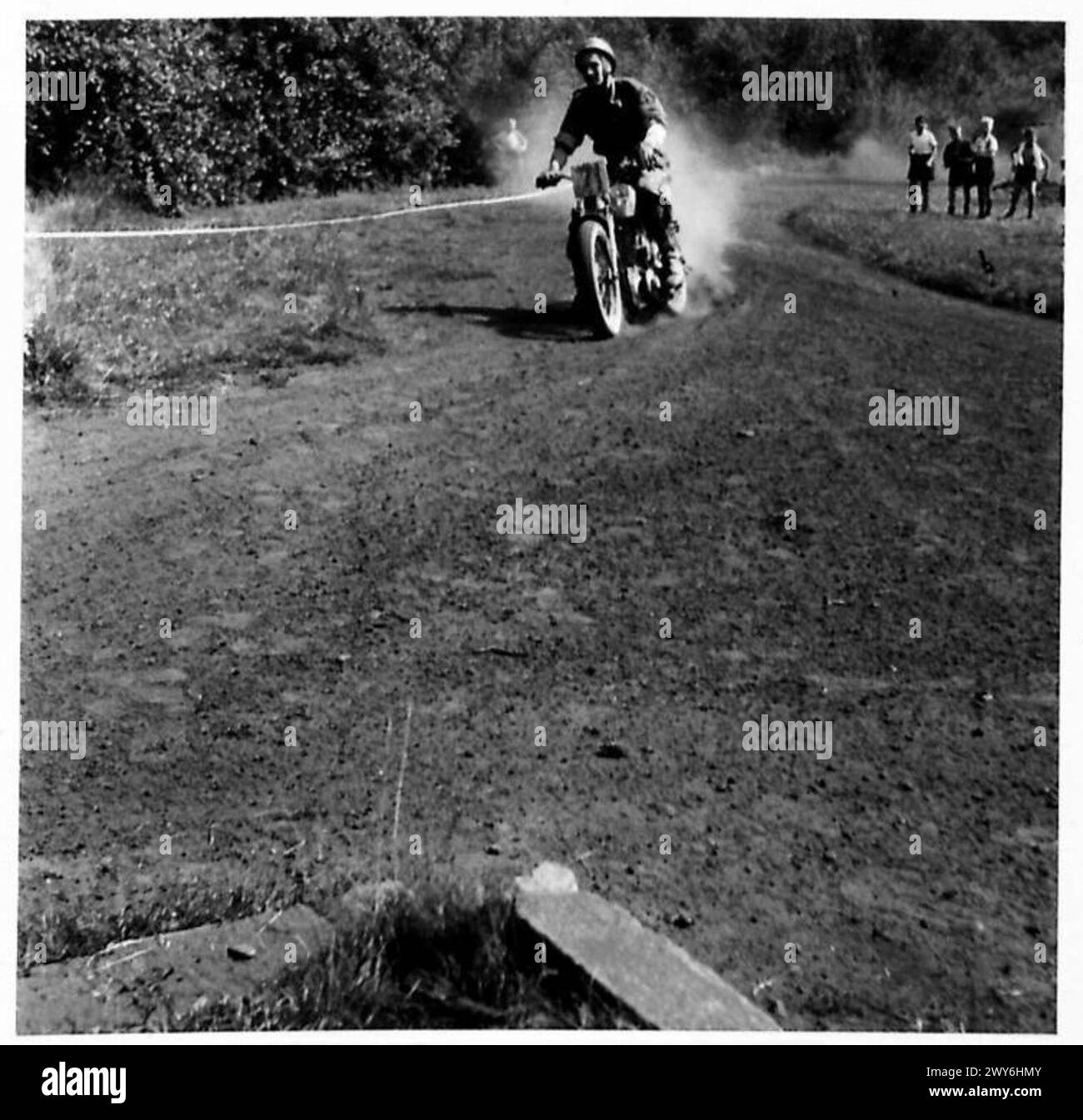 49TH DIVISION MOTOR CYCLE RACING - Taking a sharp bend on the dirt ...