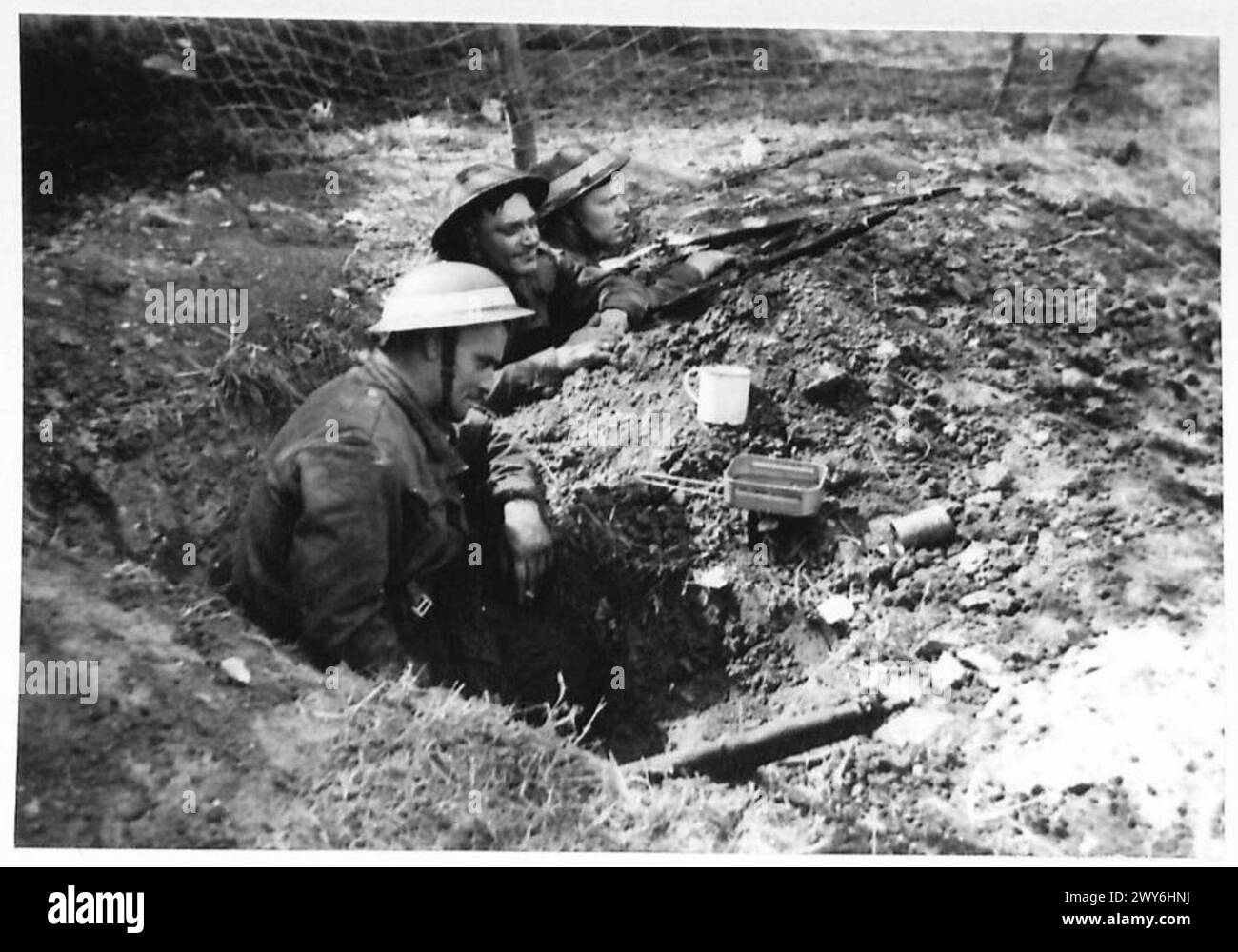 HOW THE TROOPS LIVE IN NORMANDY - "Brewing up" in a slip trench with ...