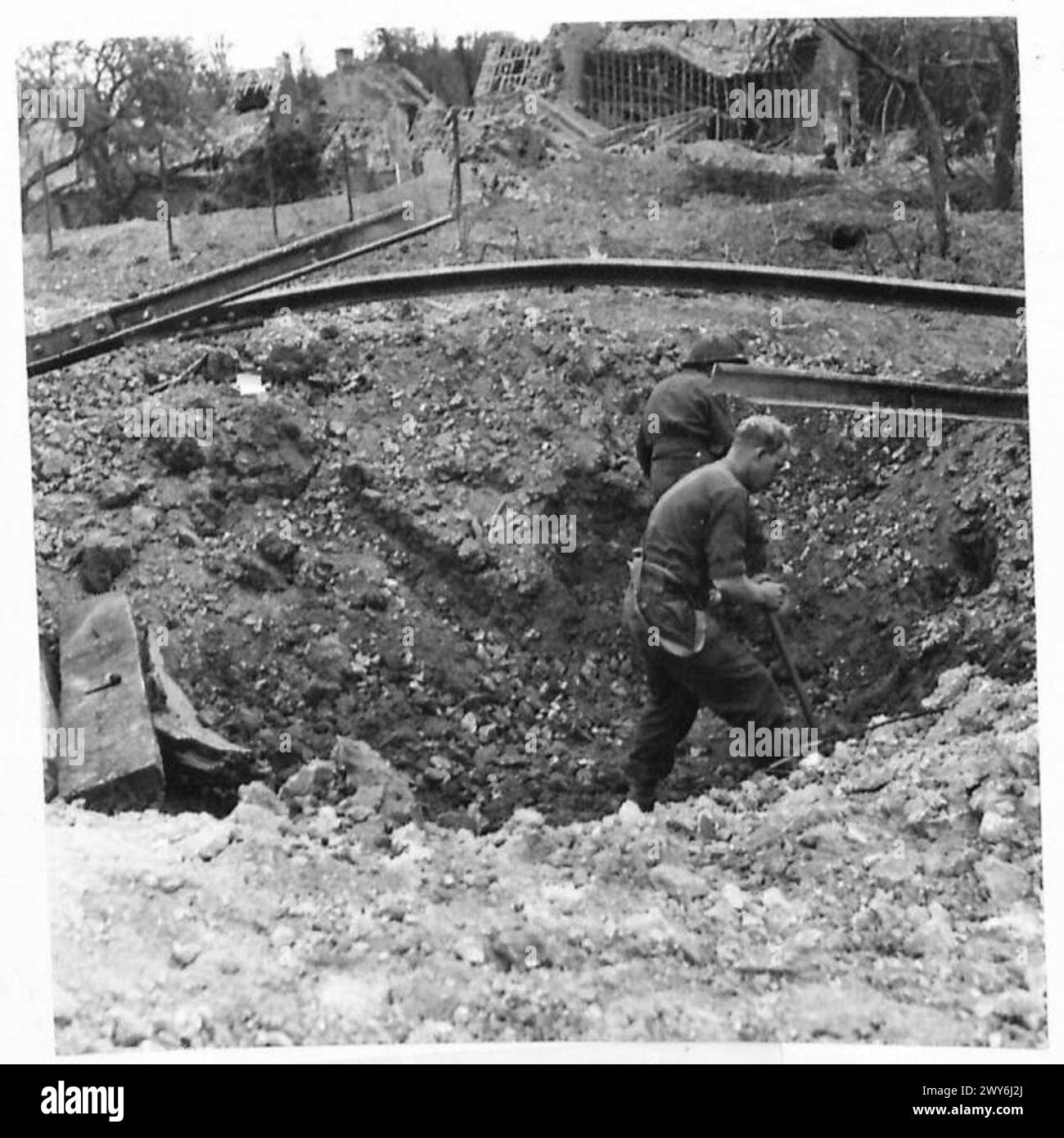 THE BREAK THROUGH IN FRANCE - Troops digging in a crater on the railway ...