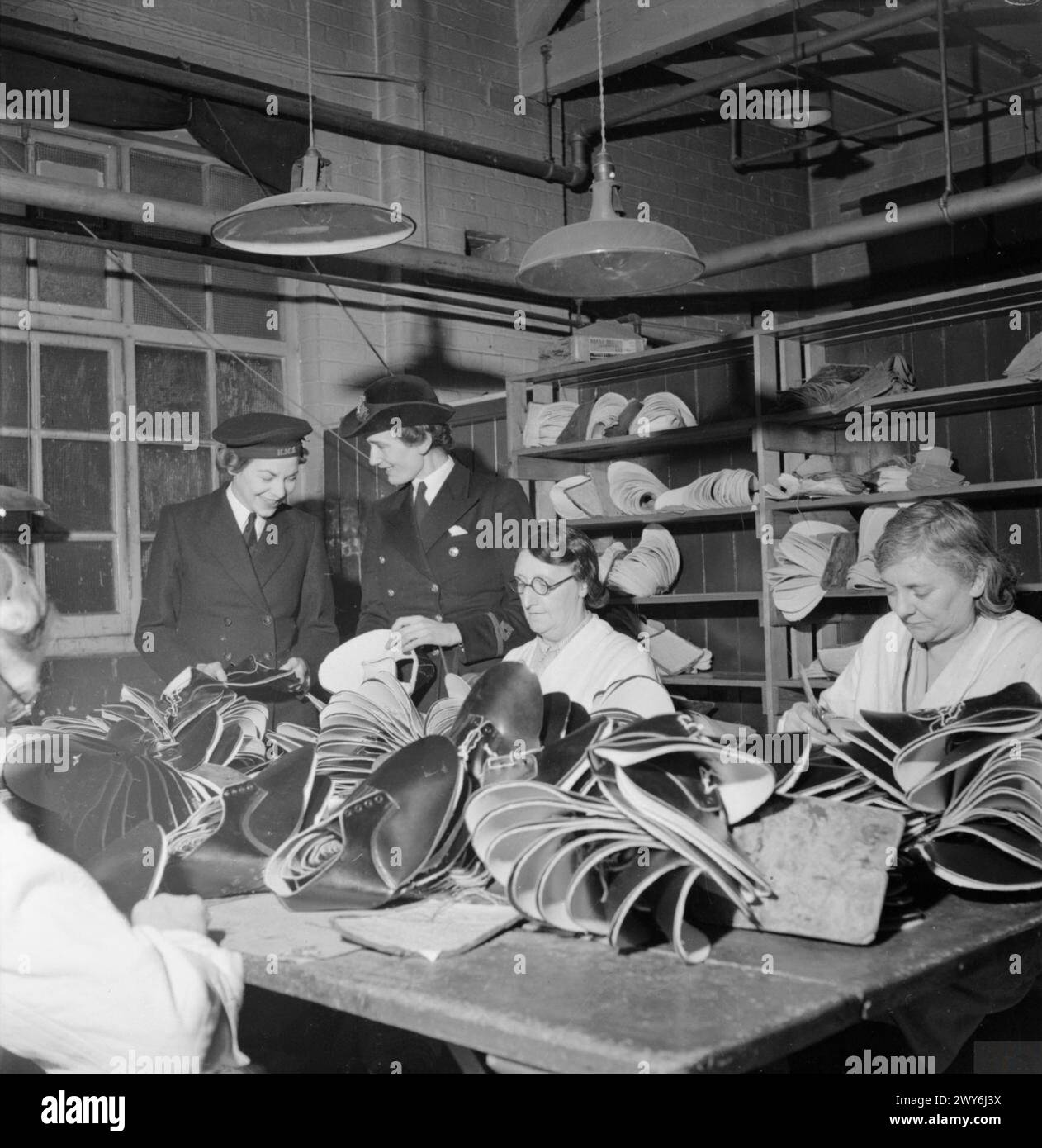 Women of the Women's Royal Naval Service supervise workers cleaning and ...