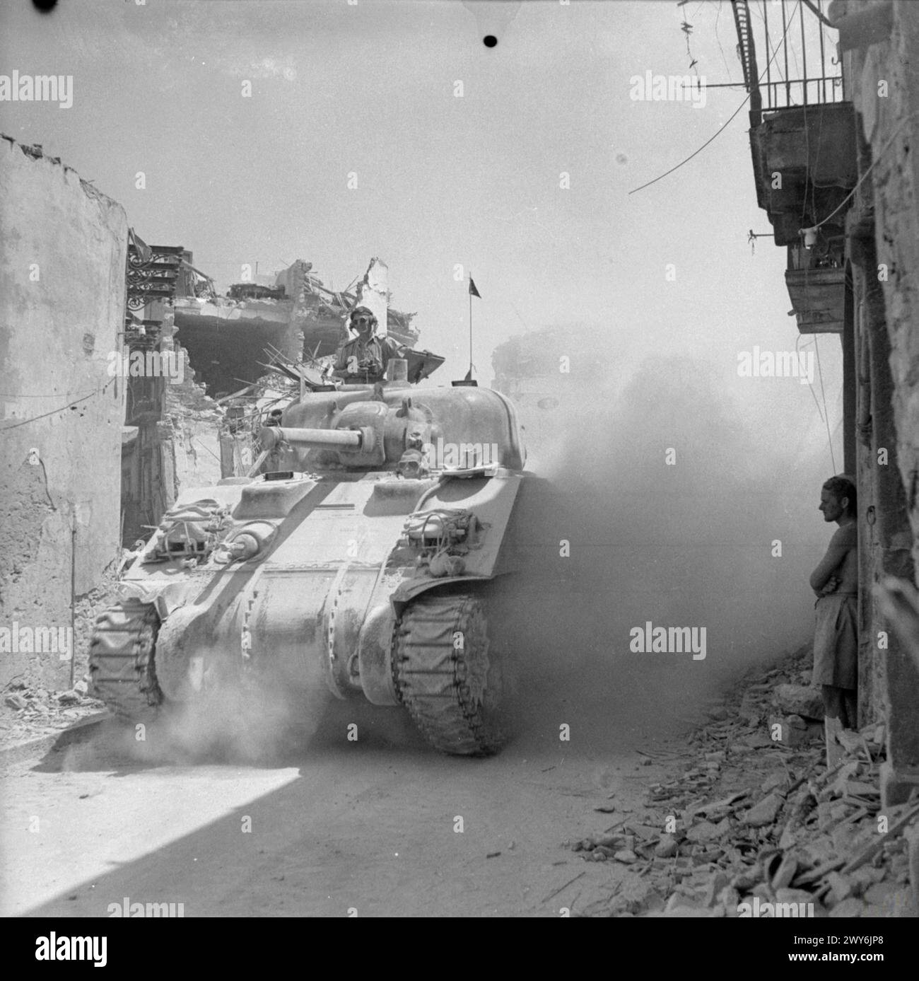 Between 10 July and 17 August 1943, a Canadian Sherman tank moves ...