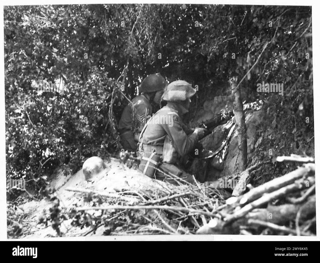 WITH THE BRITISH FORCES SOUTH OF CAUMONT - Two of our infantry make use ...