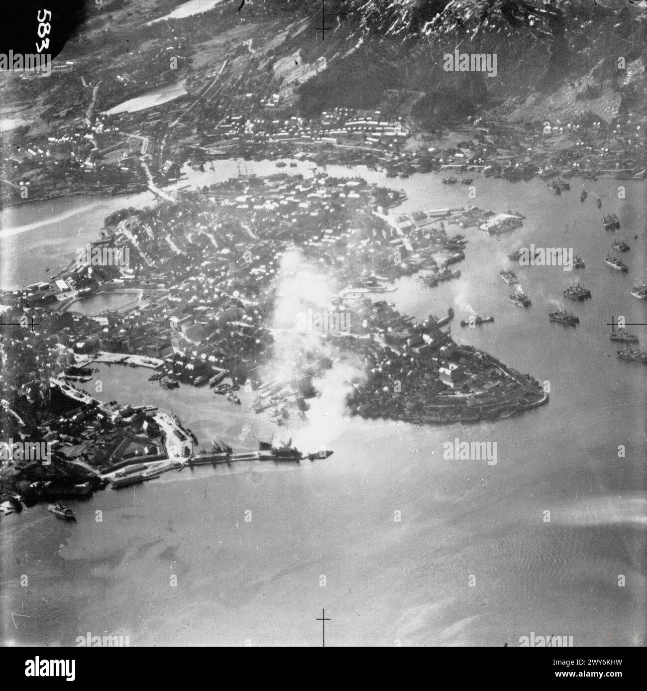 In April 1940, a German supply ship and a wharf warehouse at ...