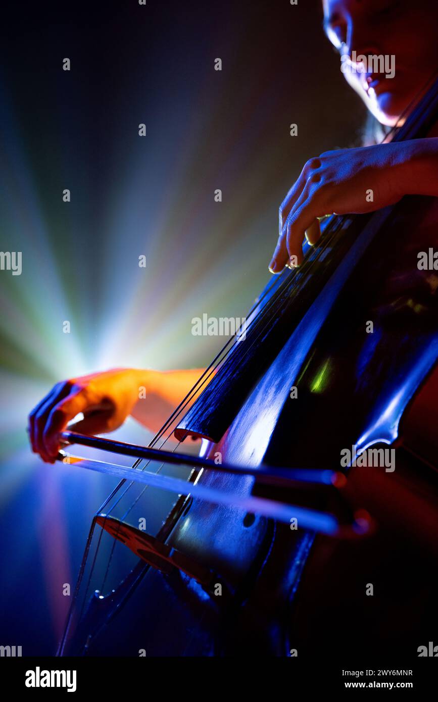Close up portrait of talented young woman, musician, cellist performing ...