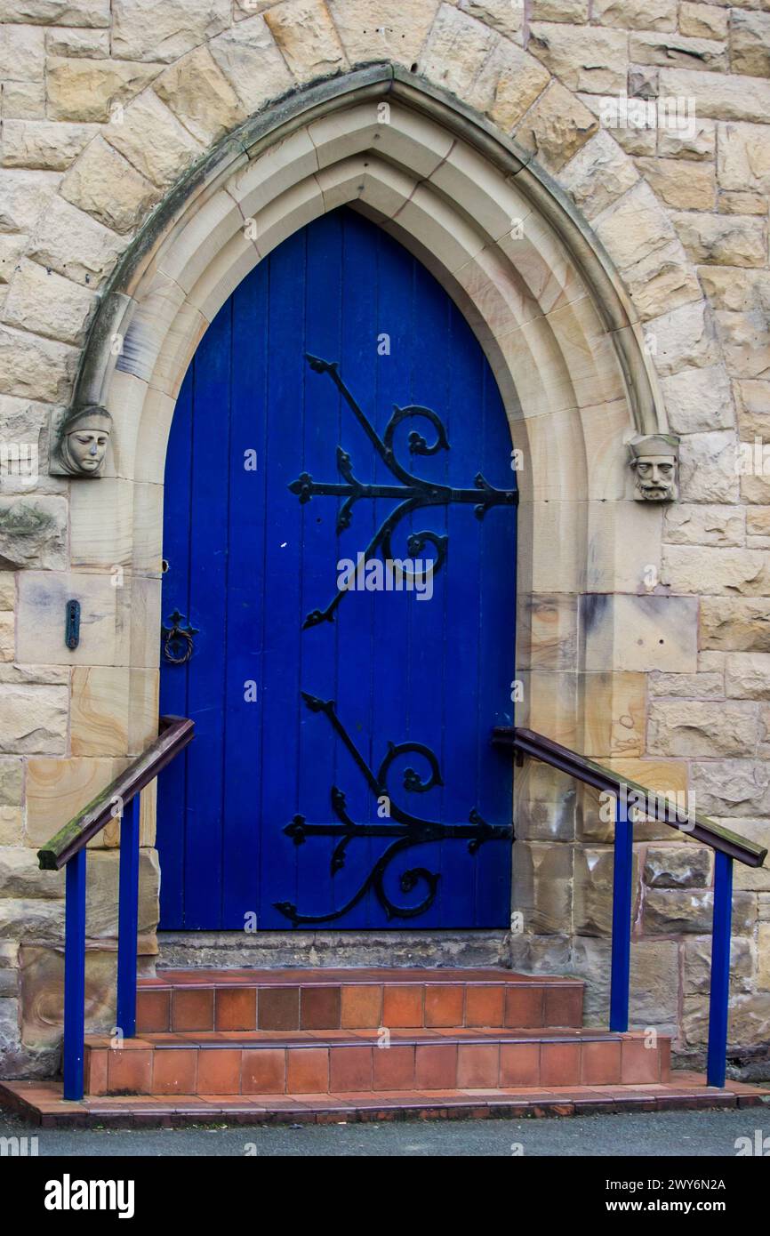 A vibrant blue door of a government building in Llangollen in Wales ...