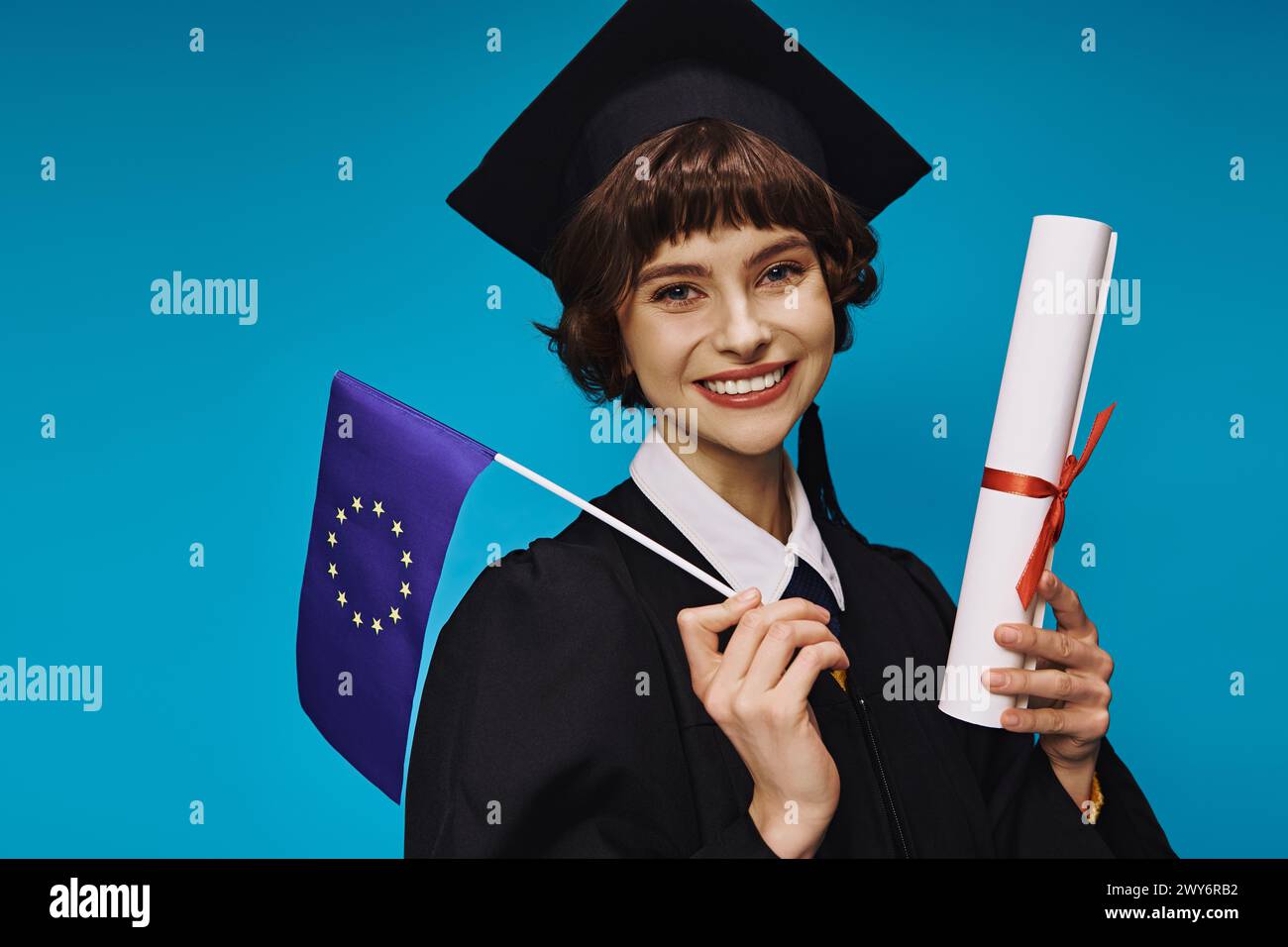 happy graduated college girl in gown and academic cap with diploma and ...