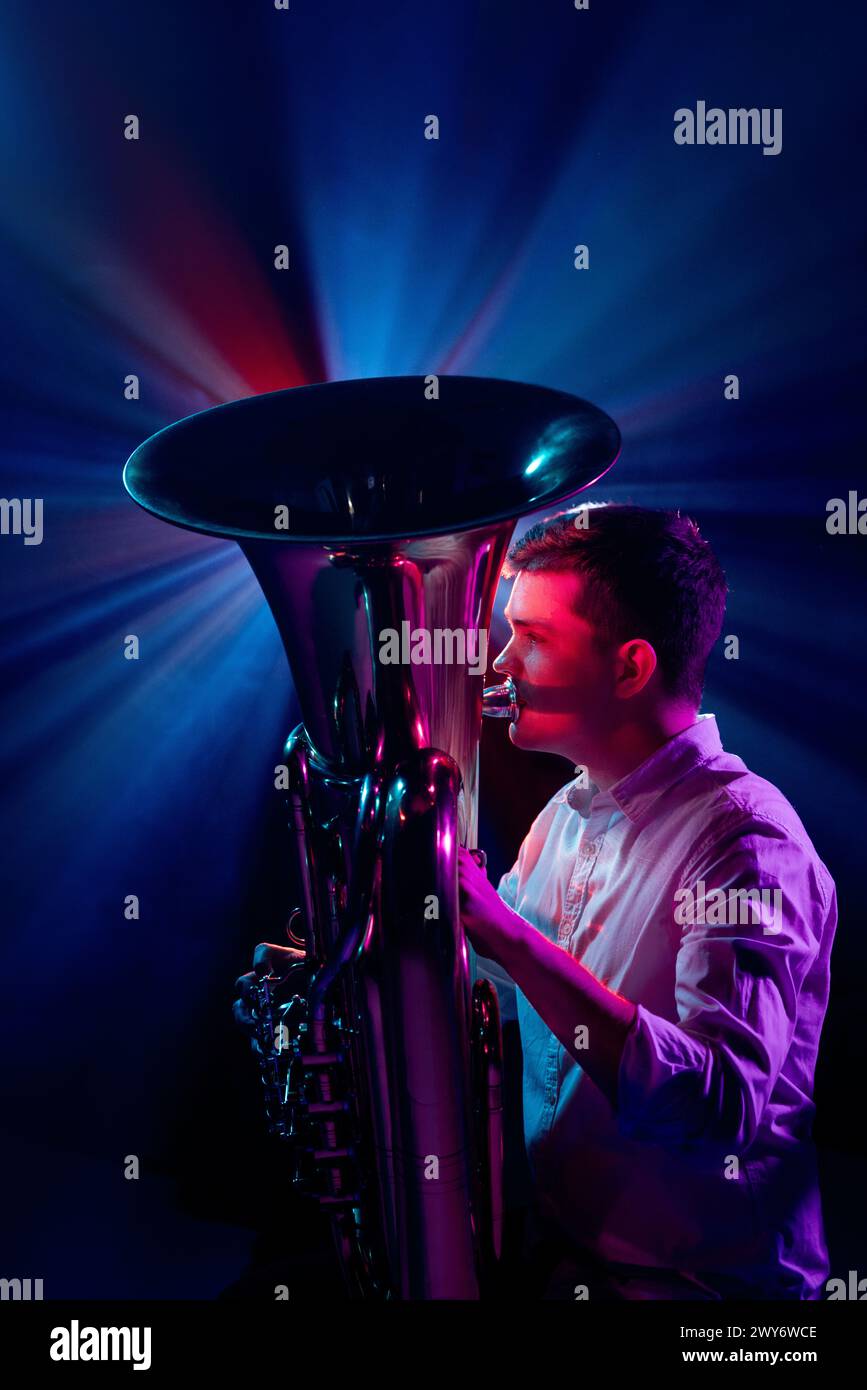 Side view photo of talented man, artistic musician seated, playing ...