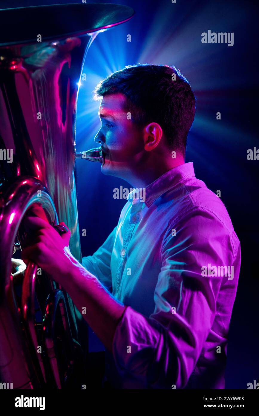 Side view photo of talented man, artistic musician seated, playing ...