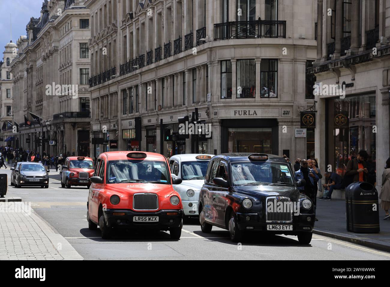 London, UK: iconic London cabs of multiple colors in a street Stock ...