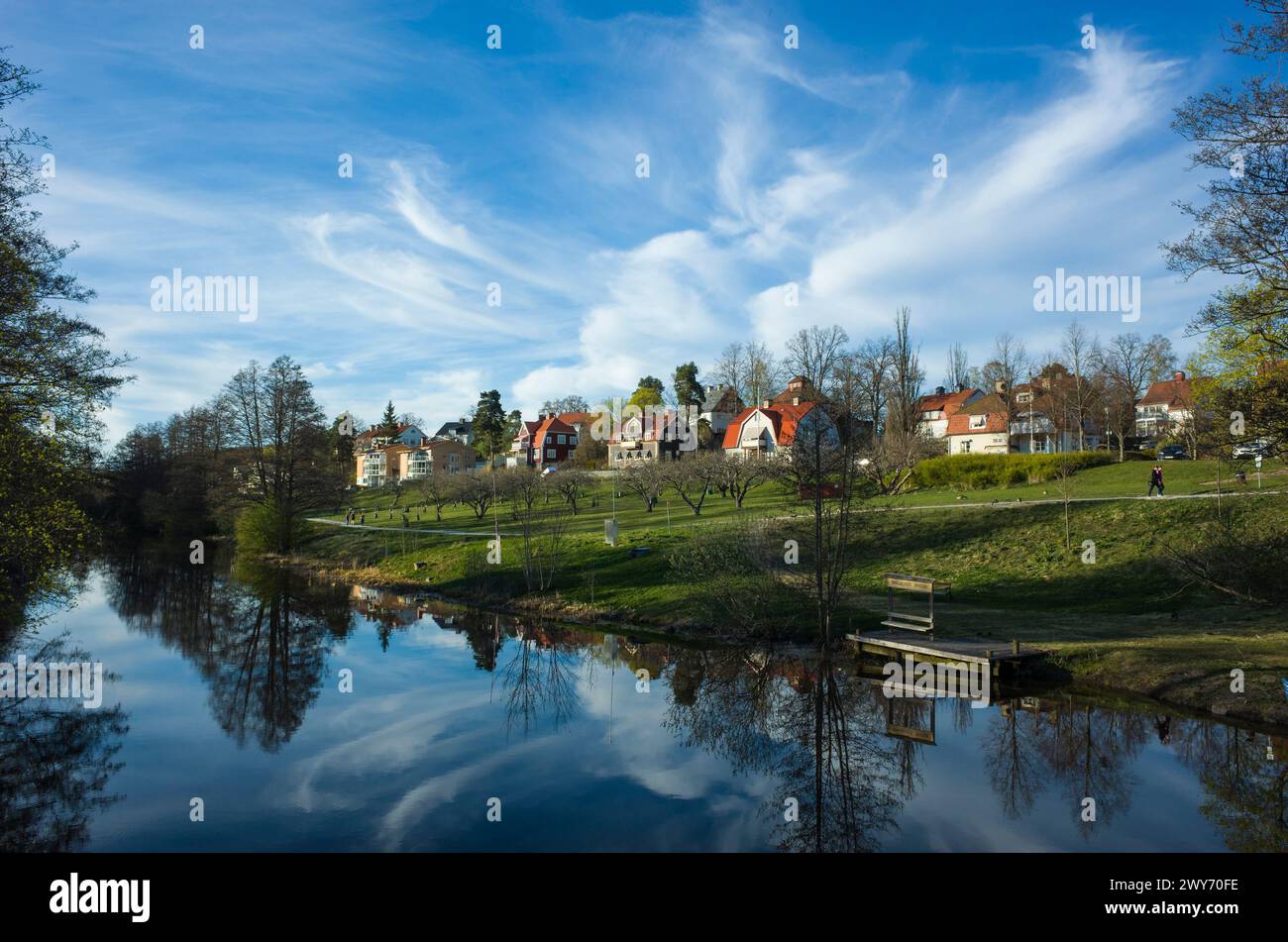 Idyllic scandinavian spring evening, amazing clouds reflecting in water ...