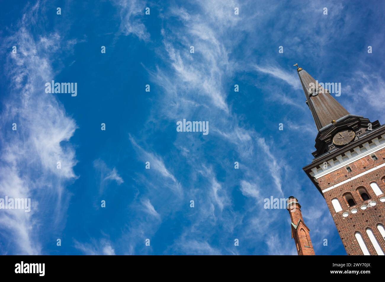 Vasteras Cathedral tower spire on blue sky with light picturesque ...