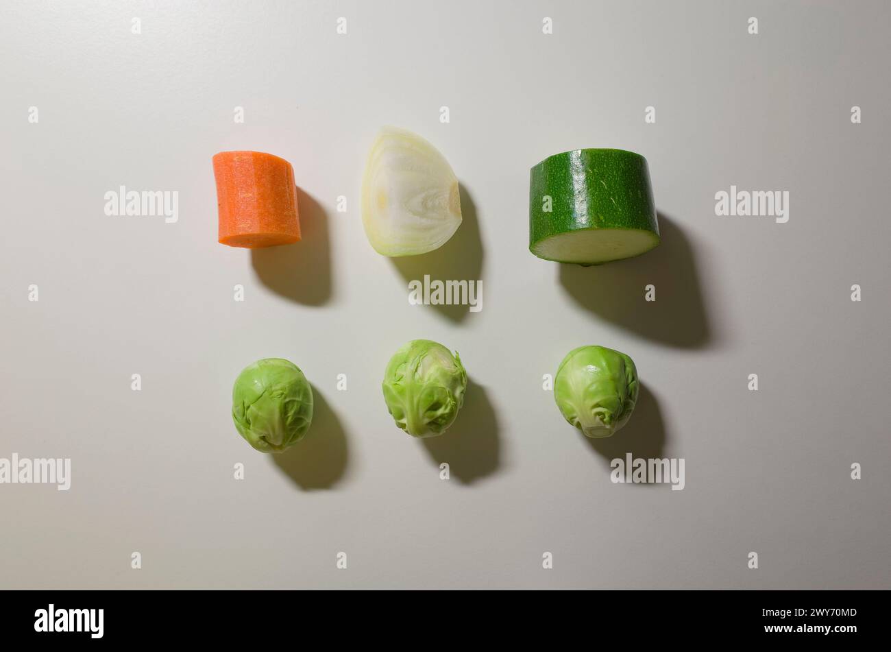 Vegetables pieces isolated on white table surface background. Healthy ...