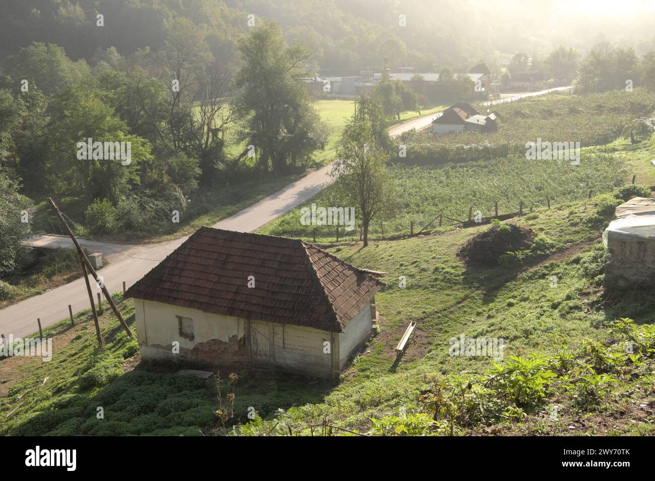 rural landscape in the morning mist between the mountains of Serbia ...