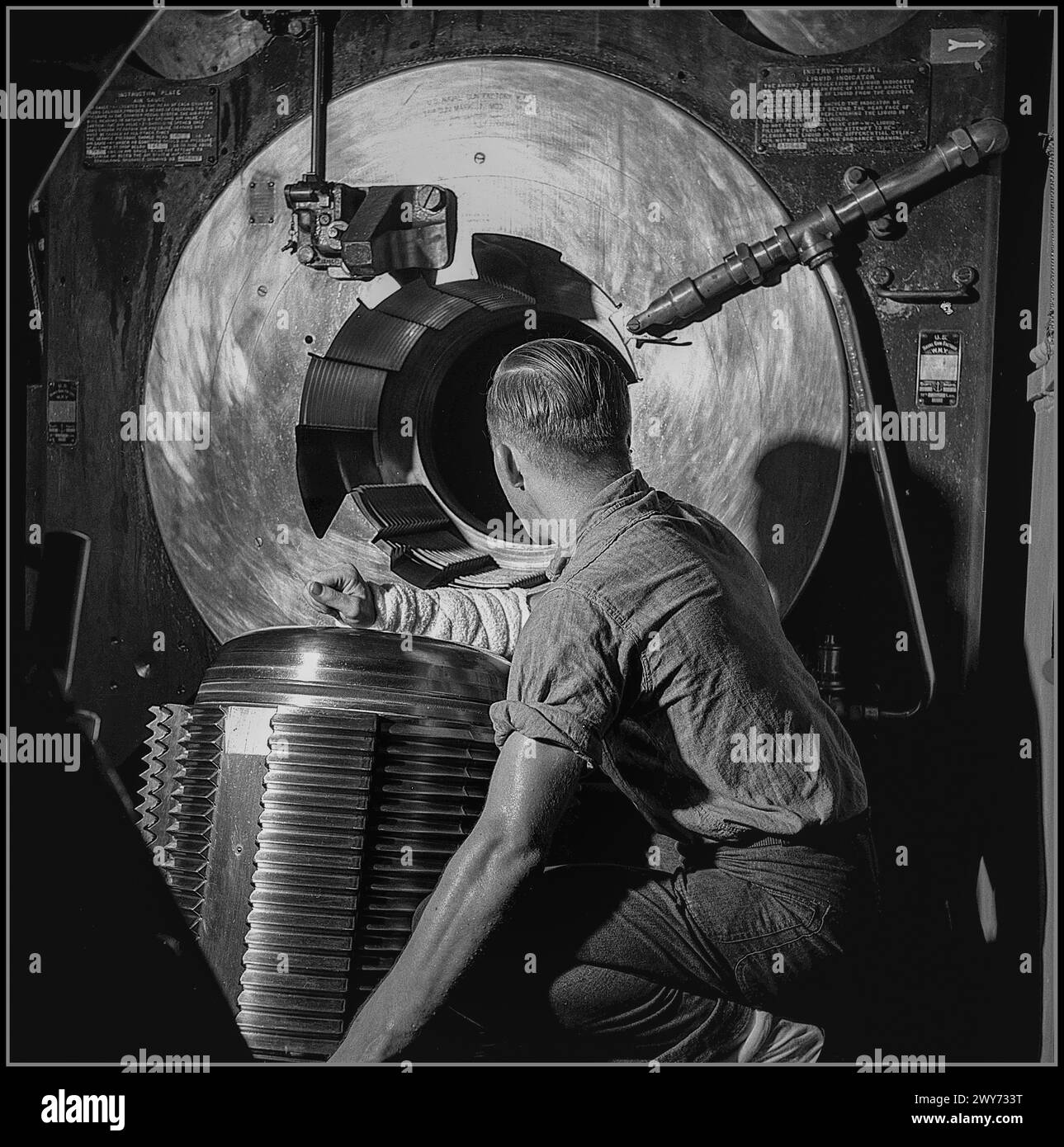 WW2 A gunnery sailor at the 406-mm main caliber gun of the American ...