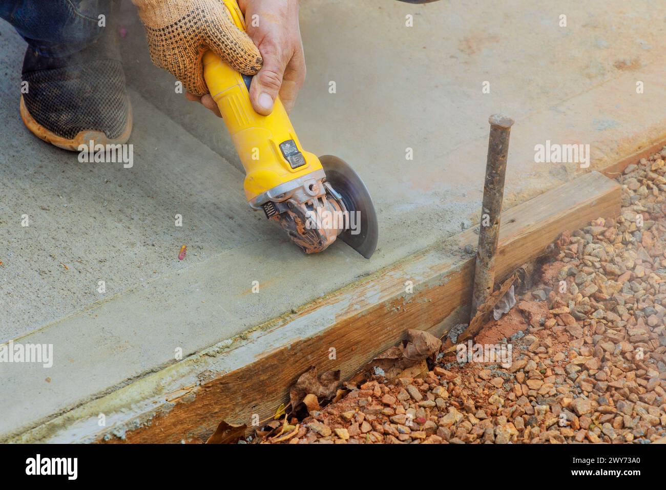 Construction worker is cutting concrete after foundation it has been ...
