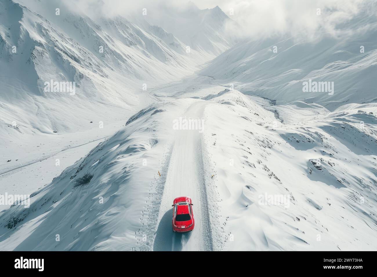 A red car maneuvers carefully down a road covered in snow, leaving ...