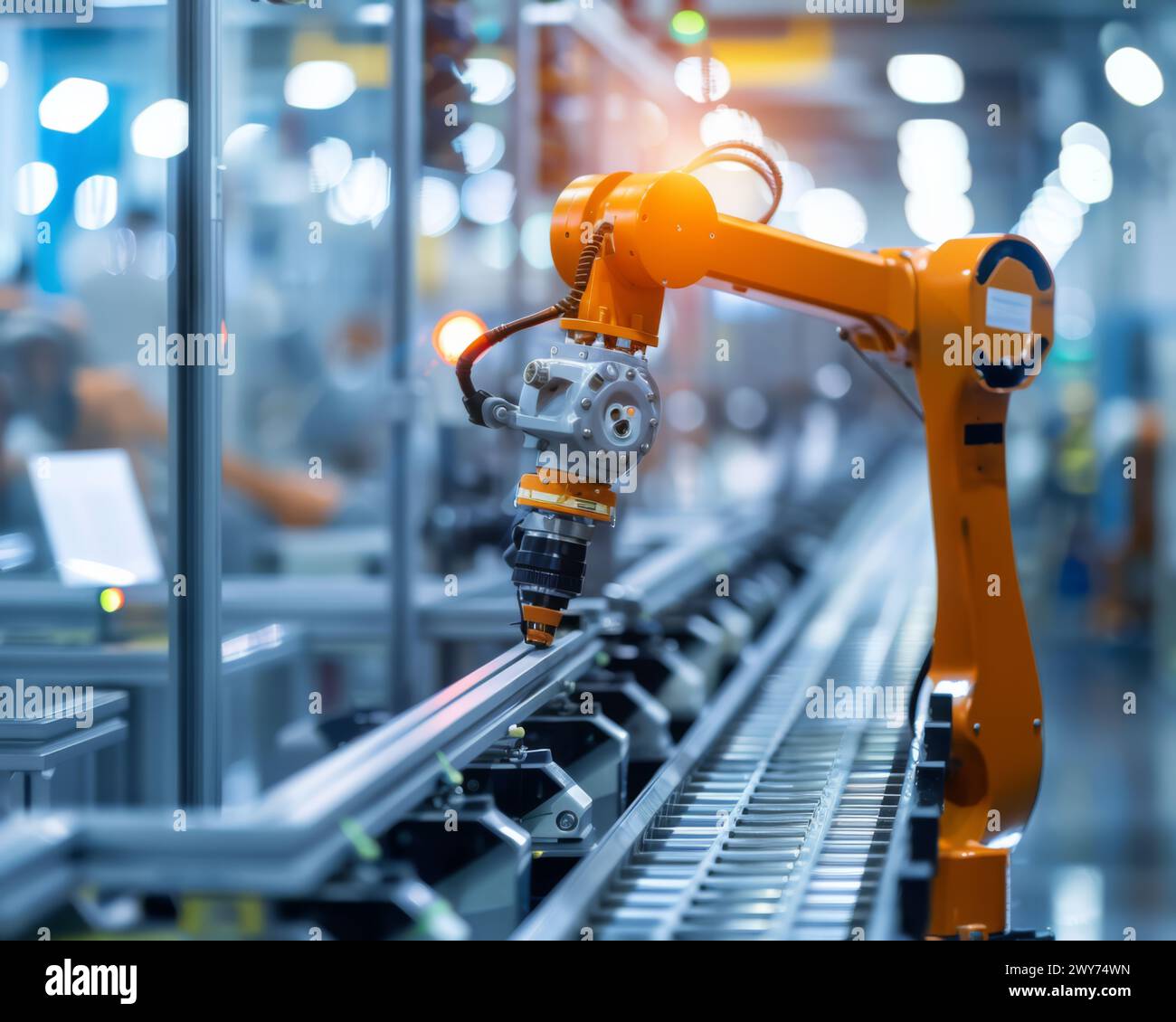 A robotic machine is seen moving along a conveyor belt in a ...
