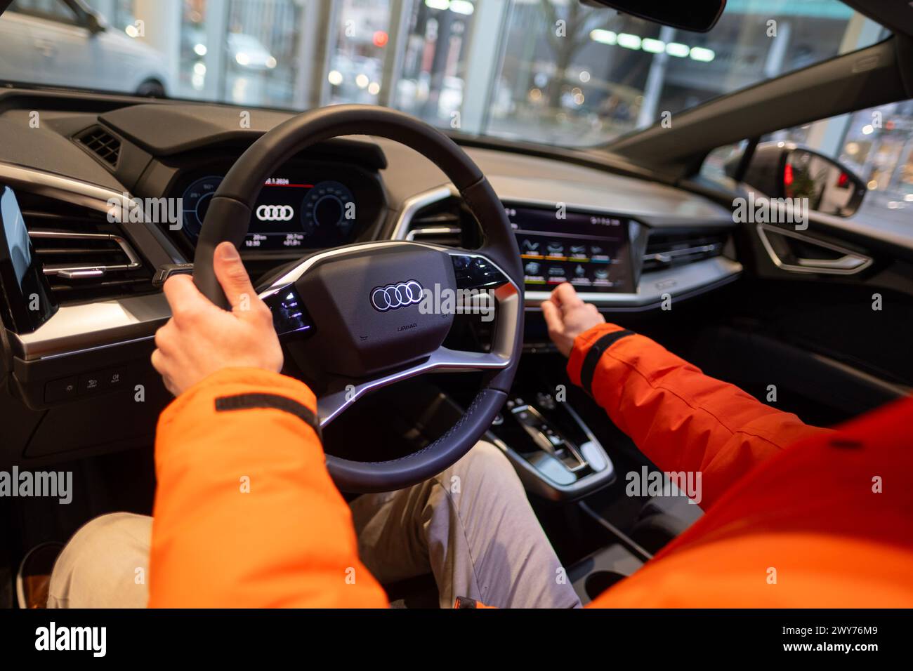 close-up man in car driving electric crossover Audi Q4 e-tron, German ...