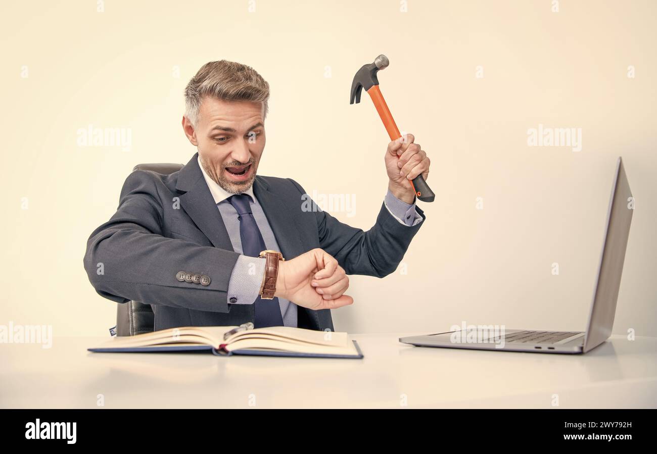 shocked boss hitting laptop with hammer and checking time Stock Photo ...