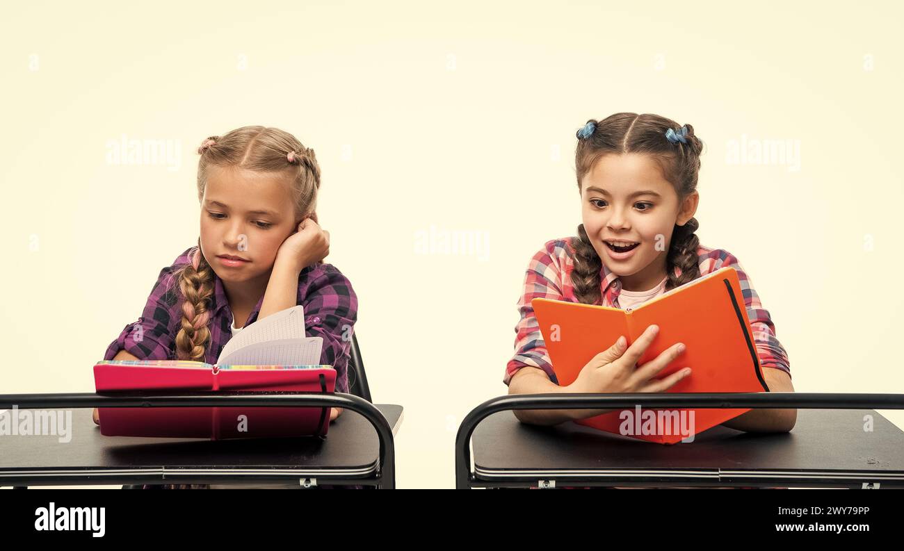 two children girls study with book at school lesson in classroom Stock ...