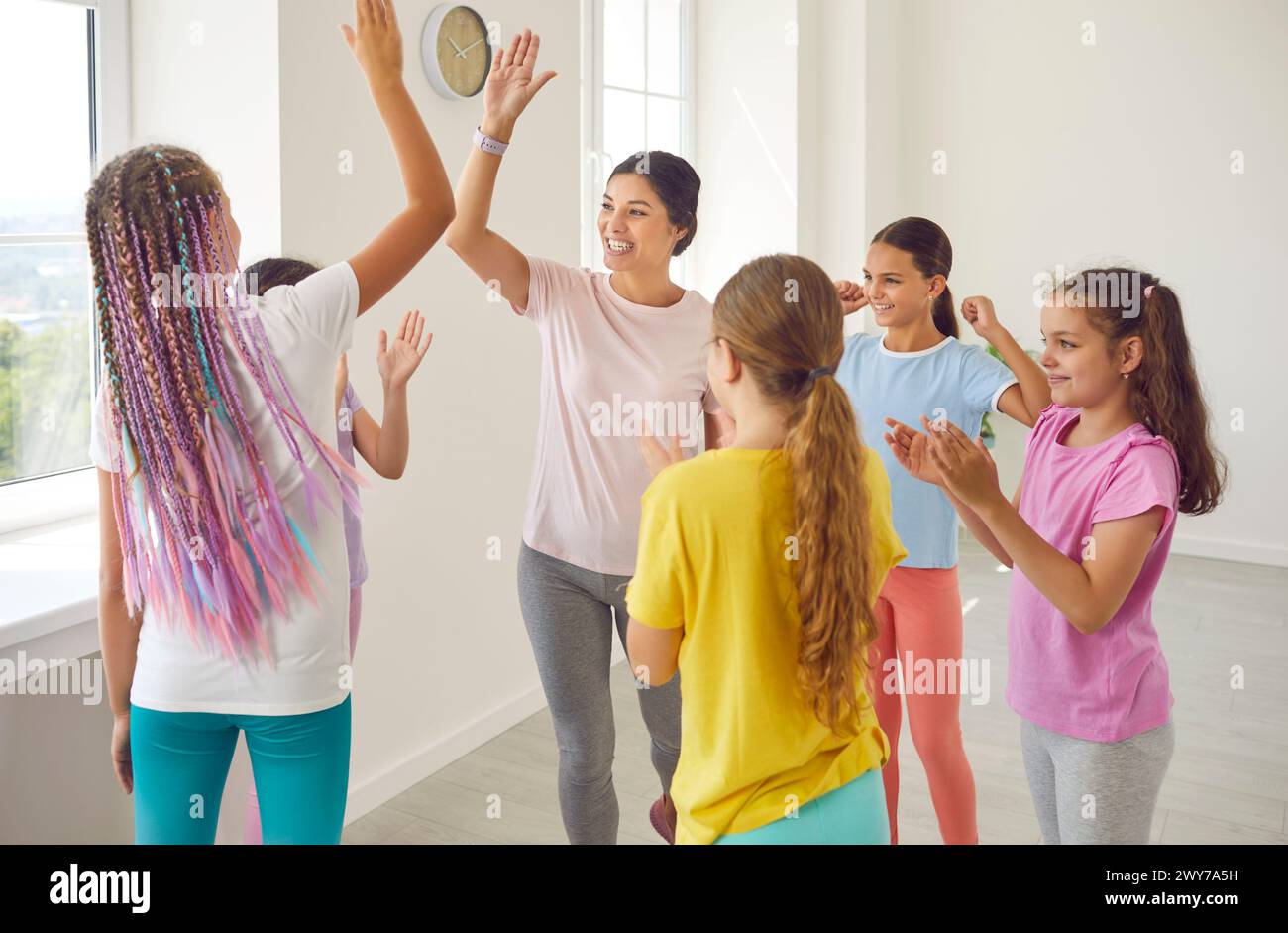 Team of happy children having fun with their sports trainer or fitness ...