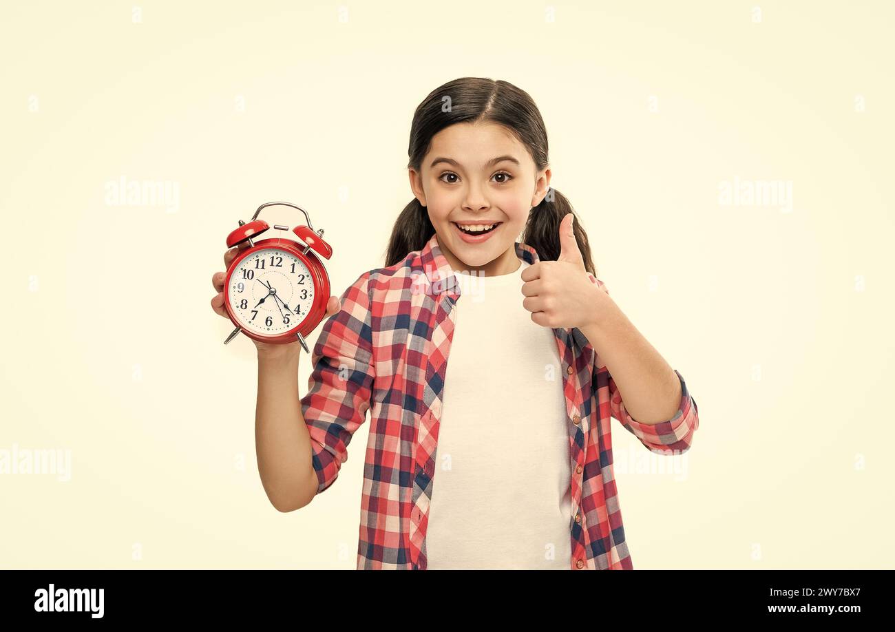 teen girl with alarm time on background, thumb up. photo of teen girl ...