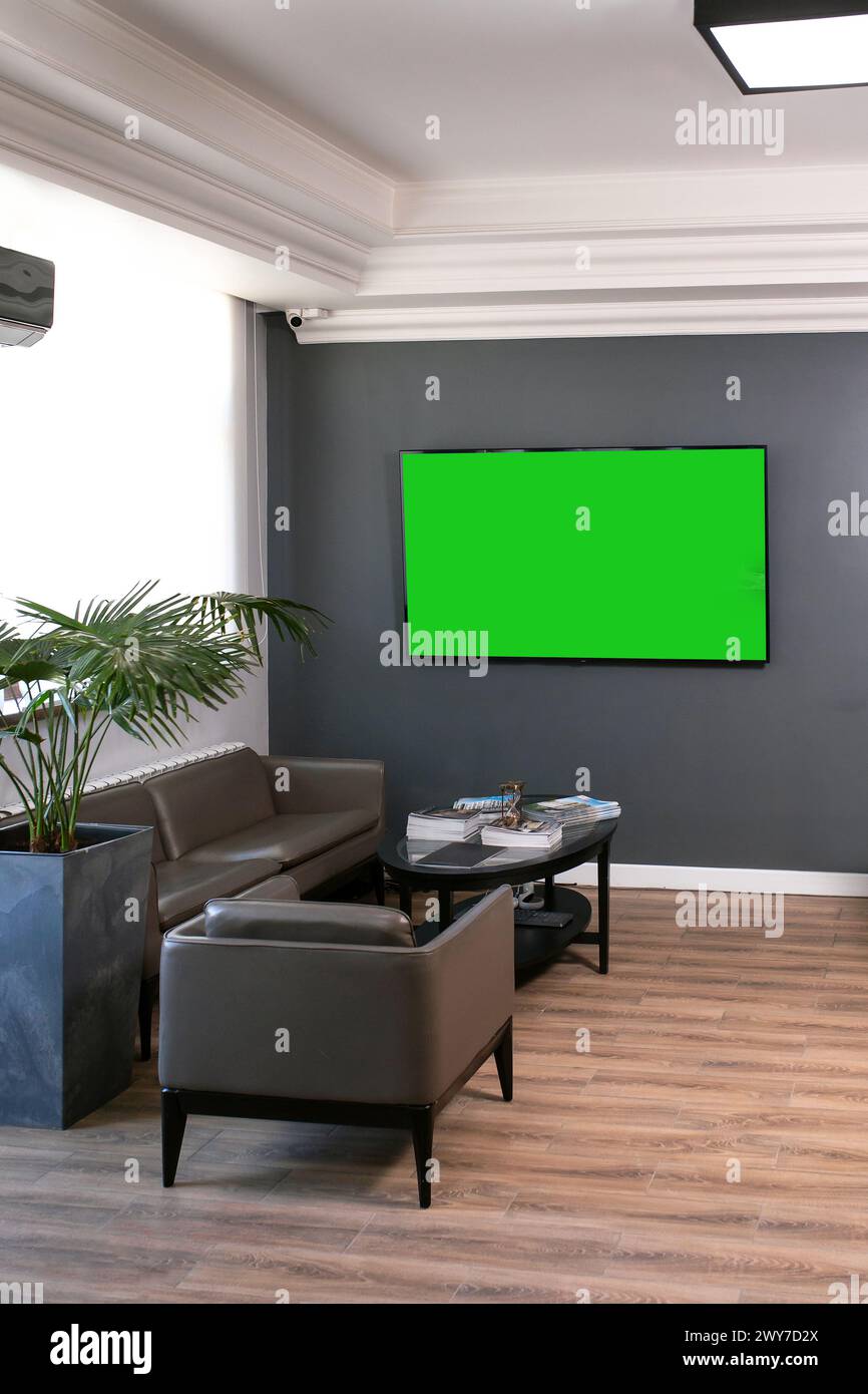 A modern and inviting reception area featuring a vibrant green living ...