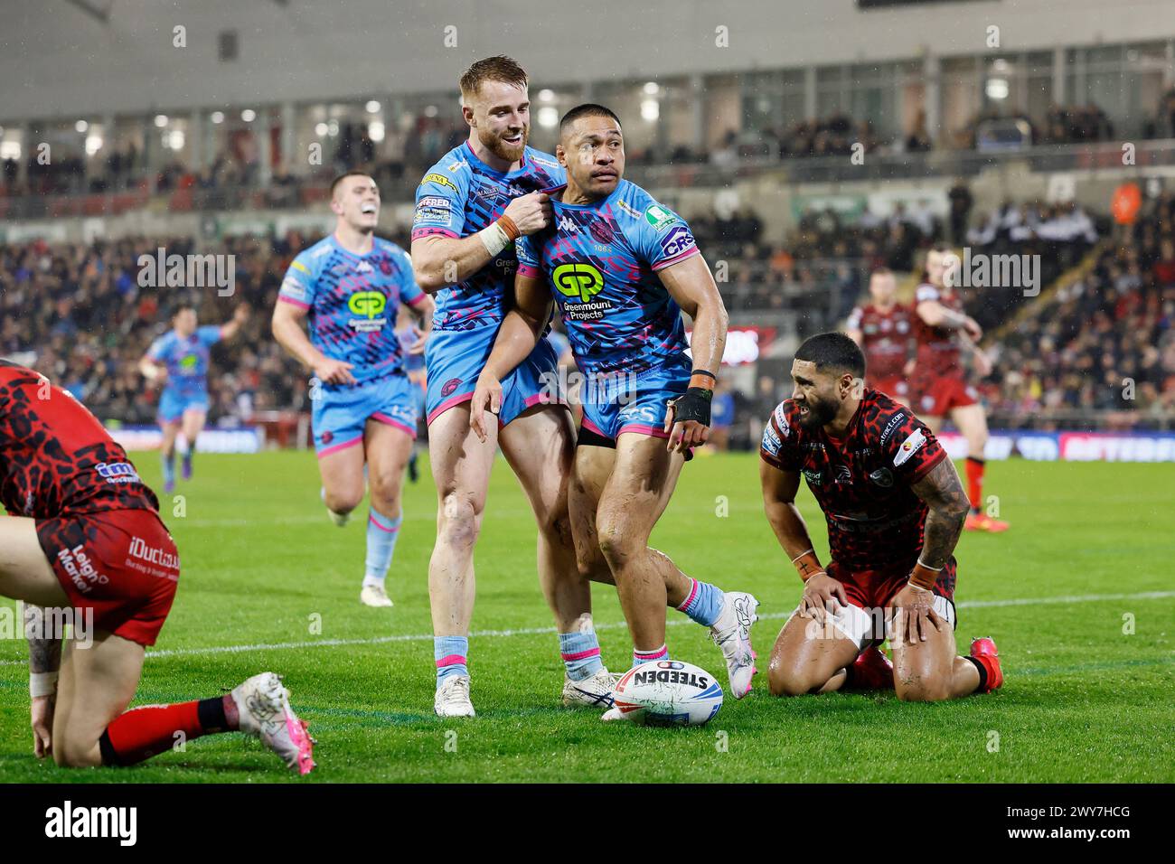 Wigan Warriors' Willie Isa (centre right) celebrates scoring their side ...