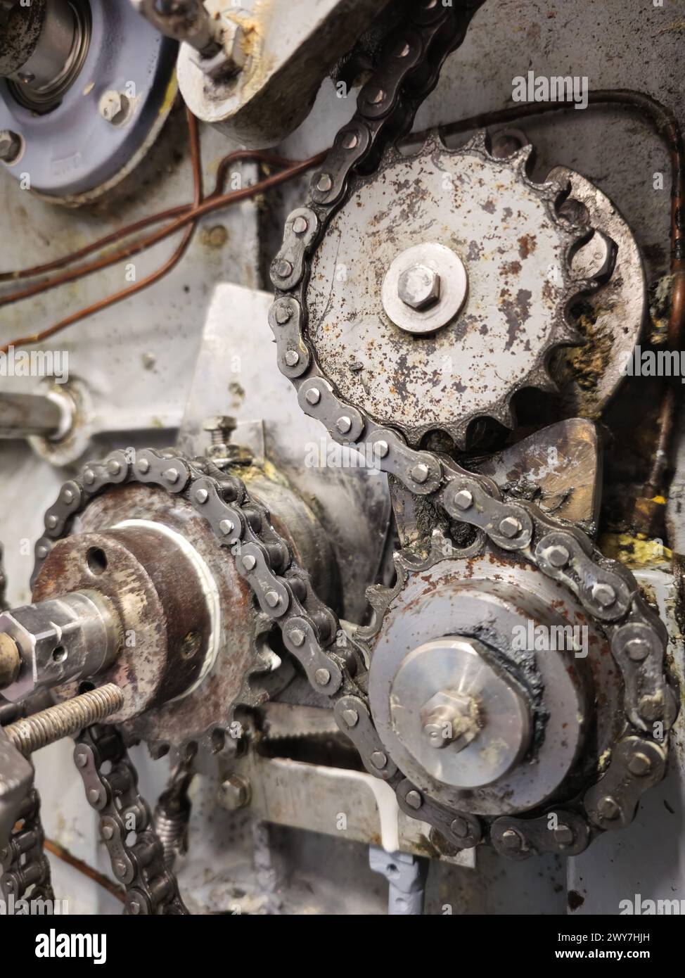 Sprockets and drive chain in an old industrial machine. Keeping ...
