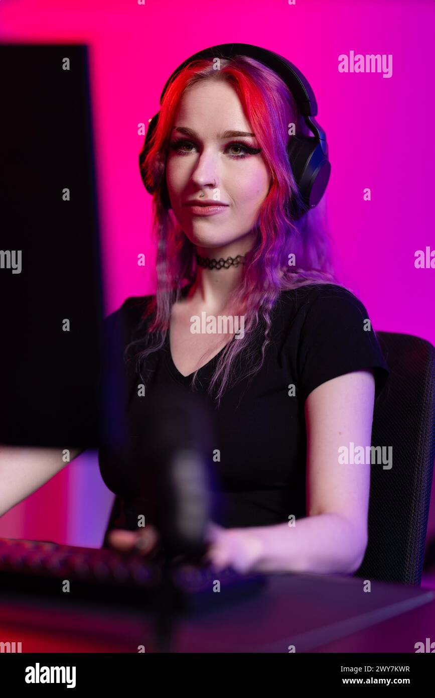 Focused Female Gamer Playing in Neon-Lit Room Stock Photo - Alamy