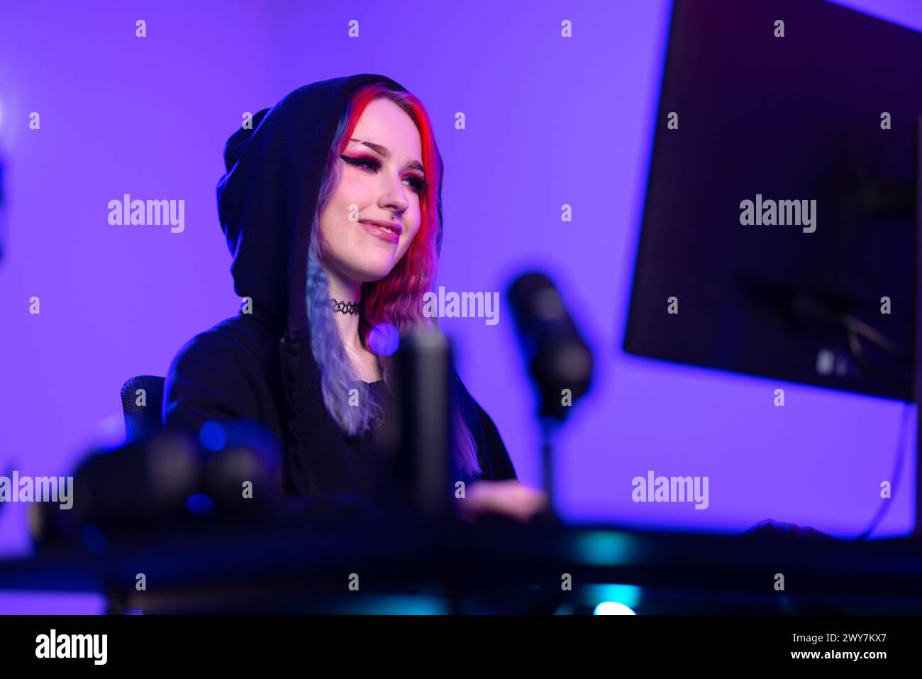 Confident Female Gamer Engaged in Competitive Gaming Stock Photo - Alamy