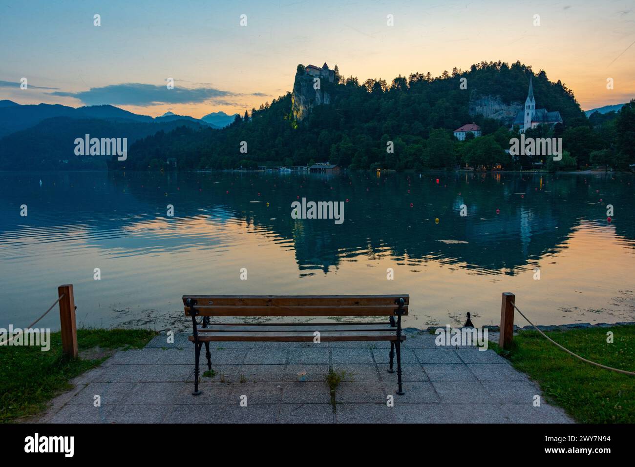Sunset view over a bench looking at Bled castle in Slovenia Stock Photo ...